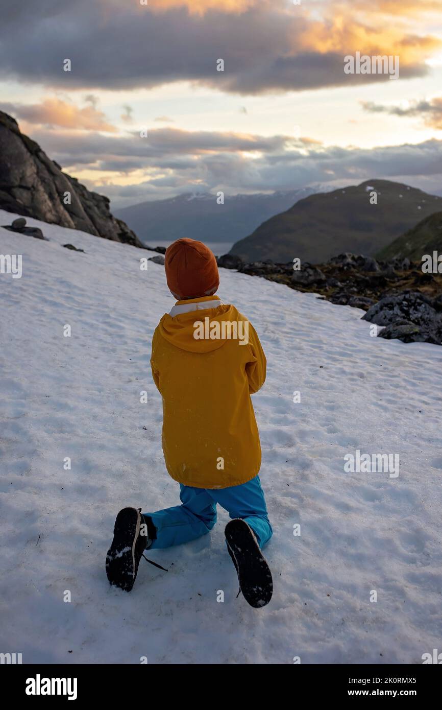 Child, boy, standing backwards, enjoying snow on mount Hoven, splendid ...