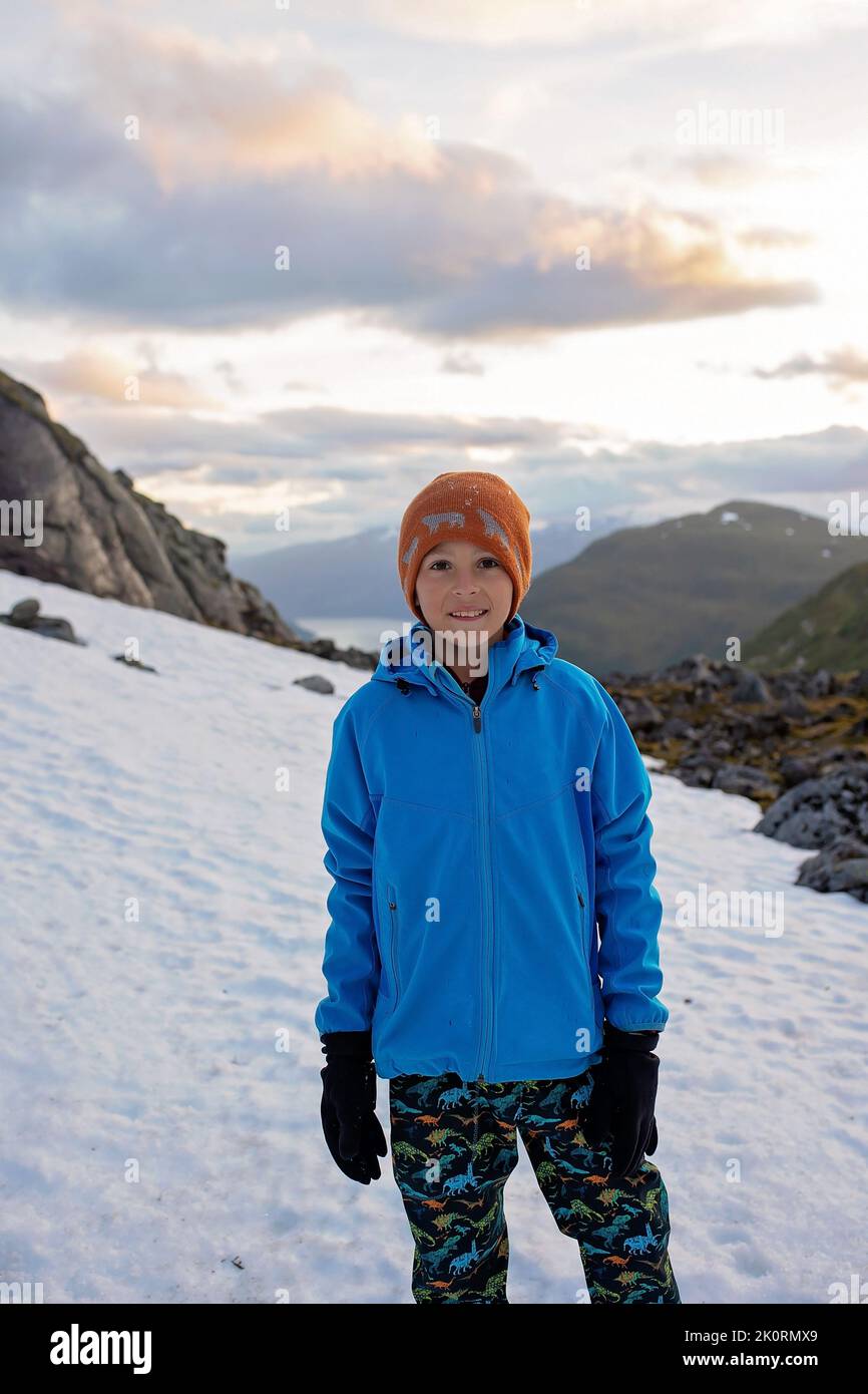 Child, boy, enjoying snow on mount Hoven, splendid view over Nordfjord ...