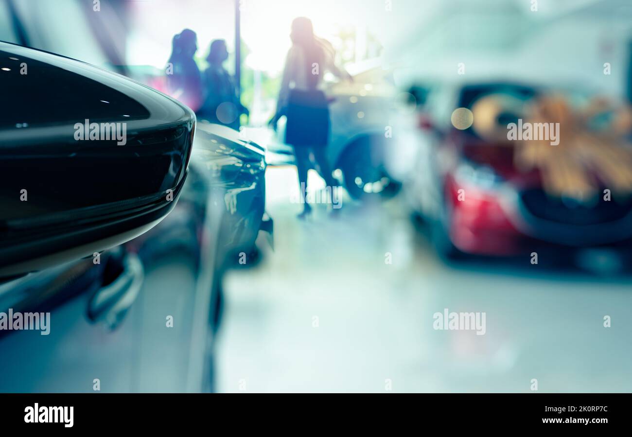 Selective side mirror car on blur saleswoman and customer in modern ...