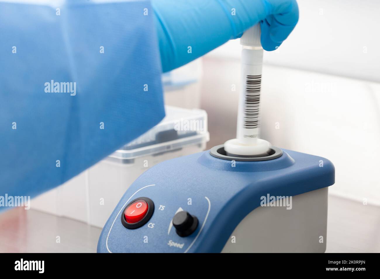 Scientist mixes a biological sample for analysis using a lab vortex ...