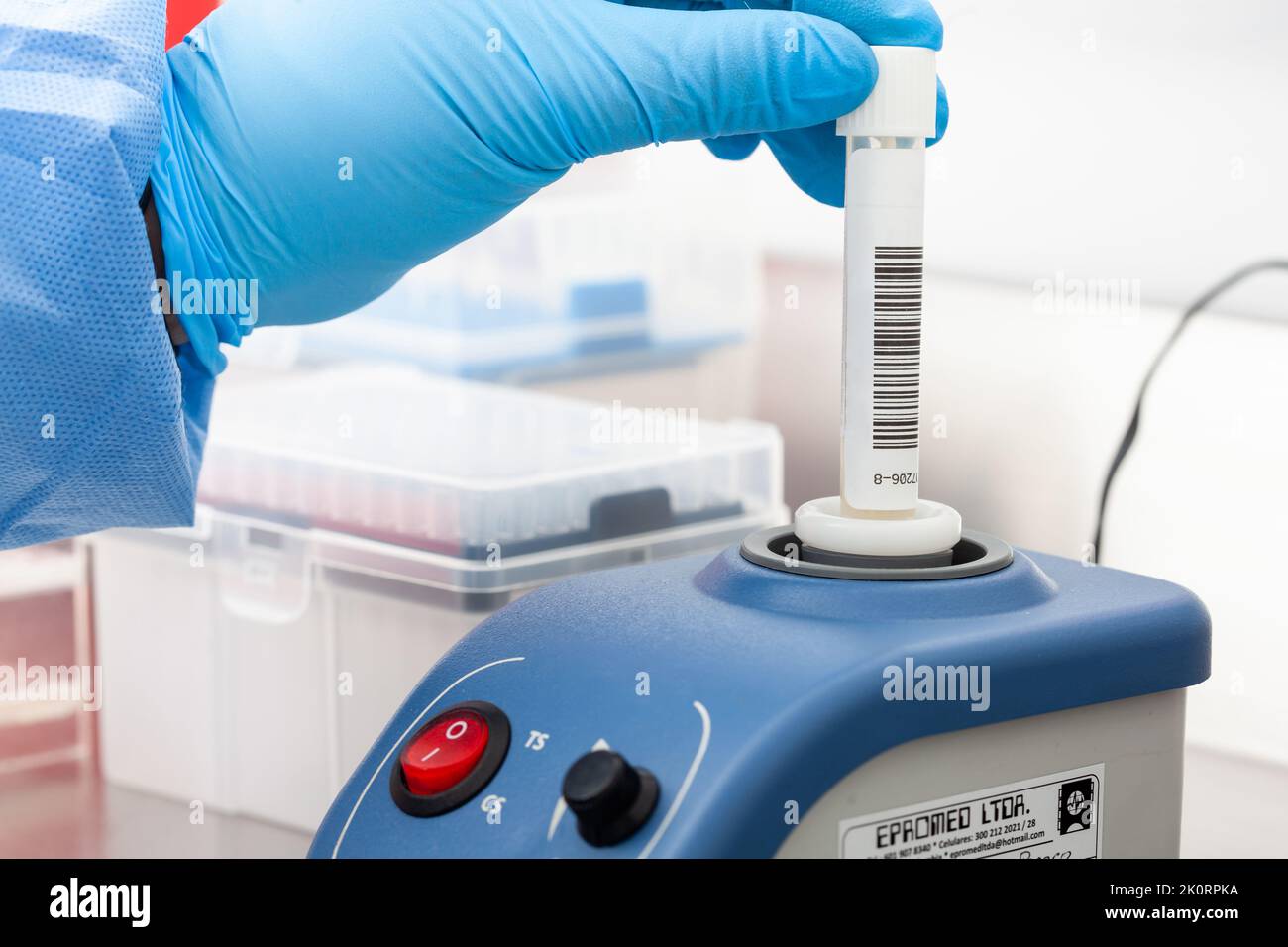 Scientist mixes a biological sample for analysis using a lab vortex ...