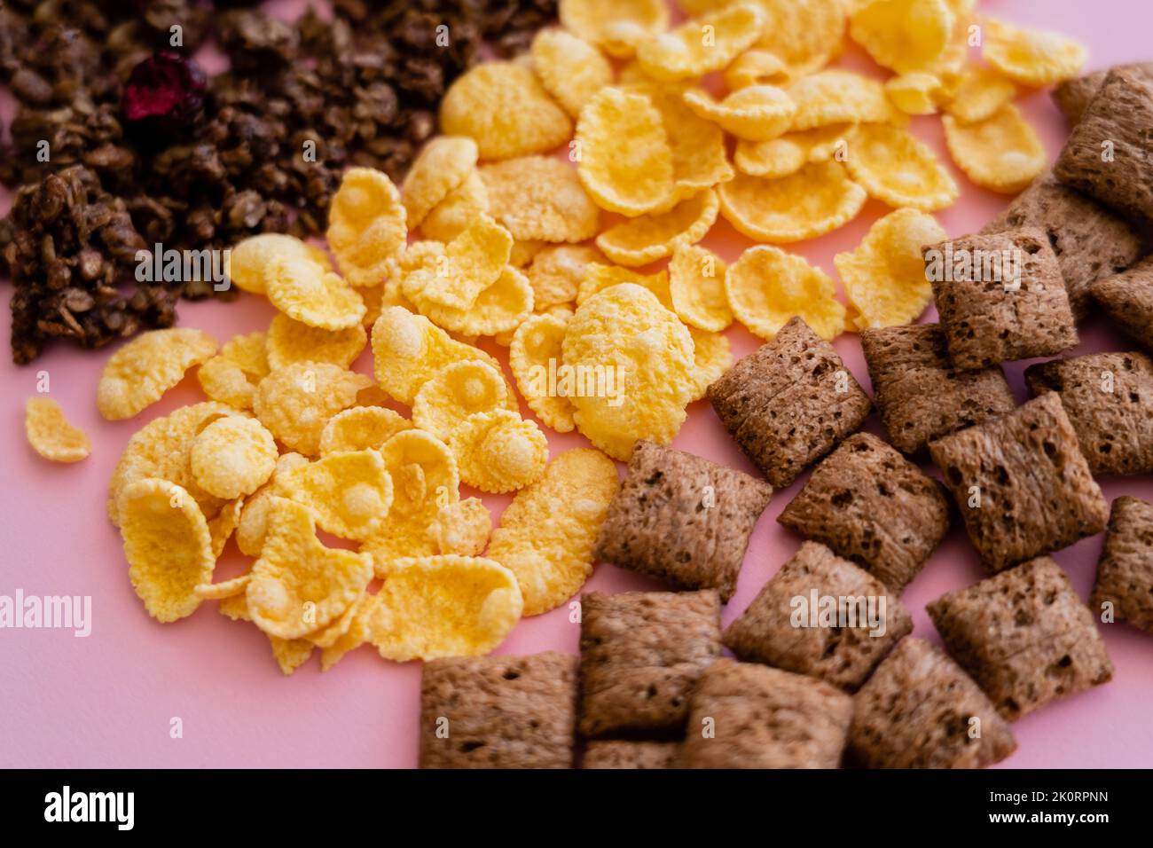 close up view of assorted breakfast corn flakes near cereal puffs and ...