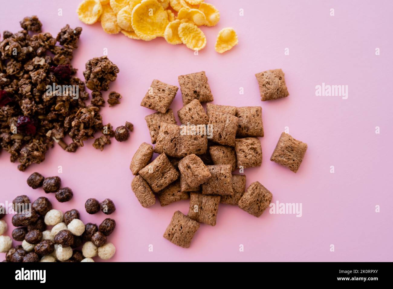 top view of various breakfast cereal corn flakes, puffs, balls and ...
