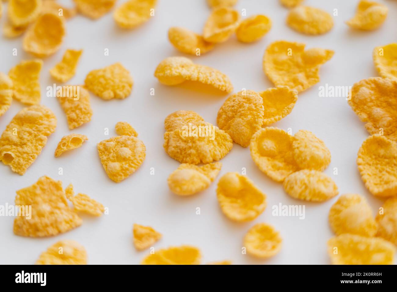 top view of crispy and dry corn flakes on white background,stock image ...