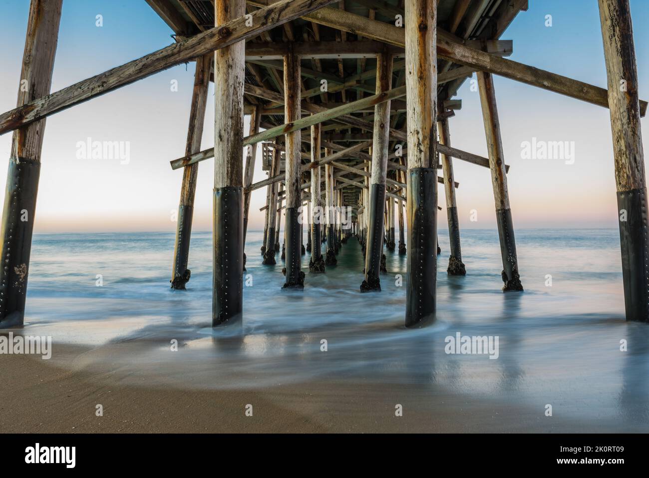 A close-up shot of the under part of a pier in Newport Beach ...