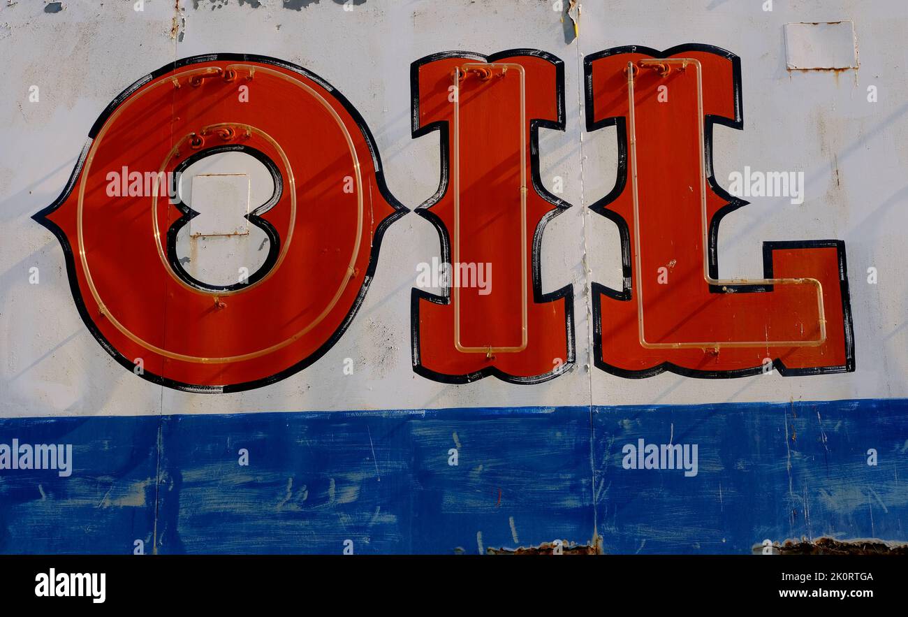 Old vintage oil sign on roadway red white and blue Stock Photo - Alamy