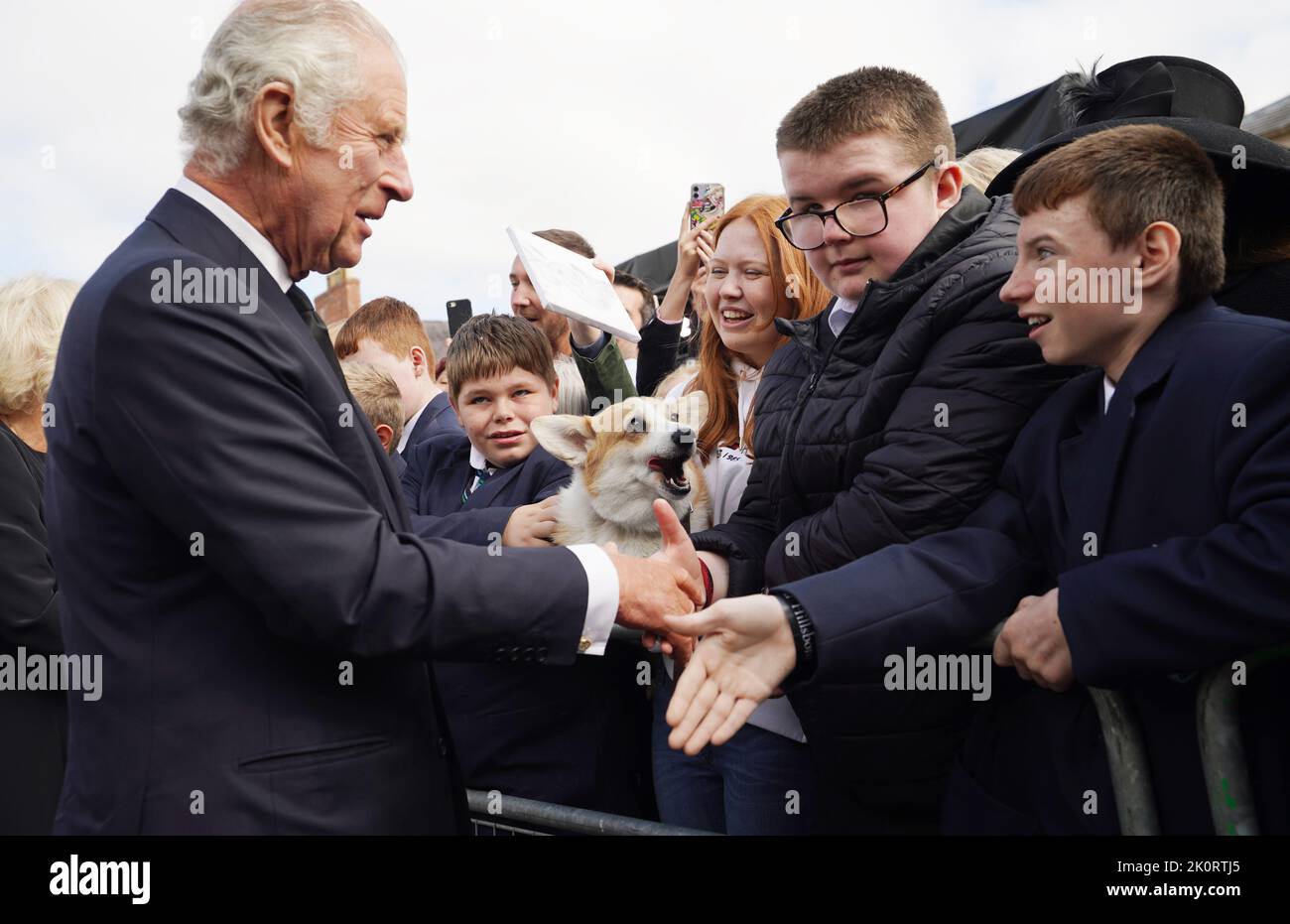 Crowds cheer including a woman with a Corgi dog as King Charles III and ...