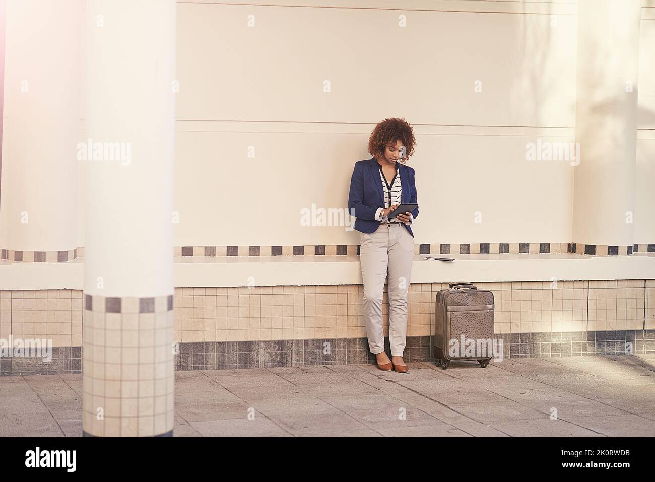 Checking in with the office. A businesswoman using a digital tablet ...