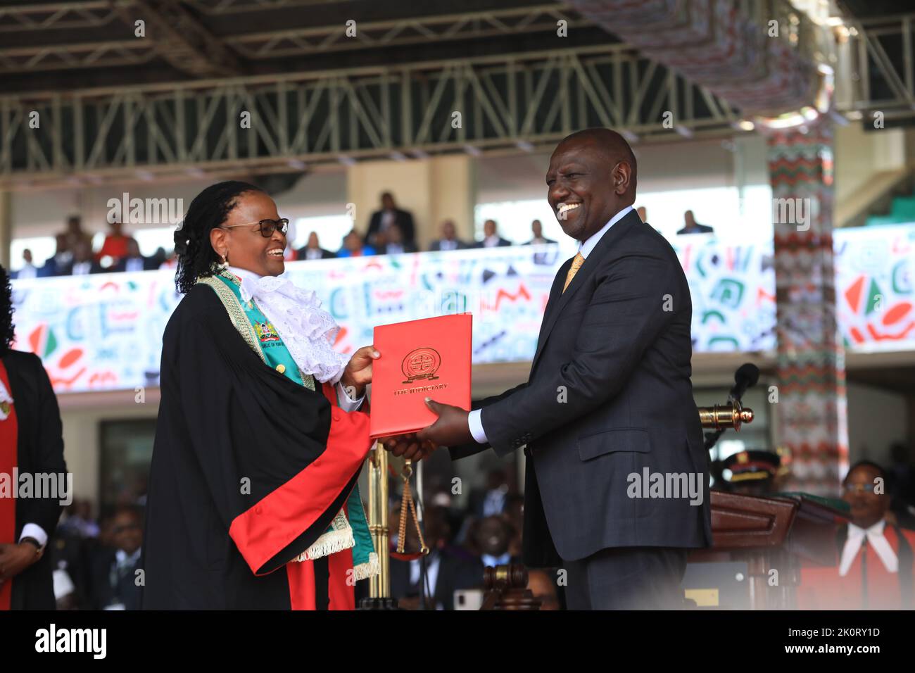 Chief justice of the Supreme Court Martha Koome hands president William Ruto a certificate ...
