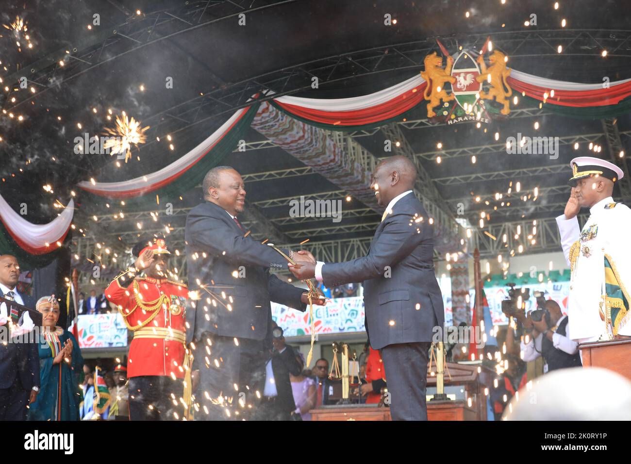 Former president Uhuru Kenyatta hands president William Ruto a sword during the swearing in ...
