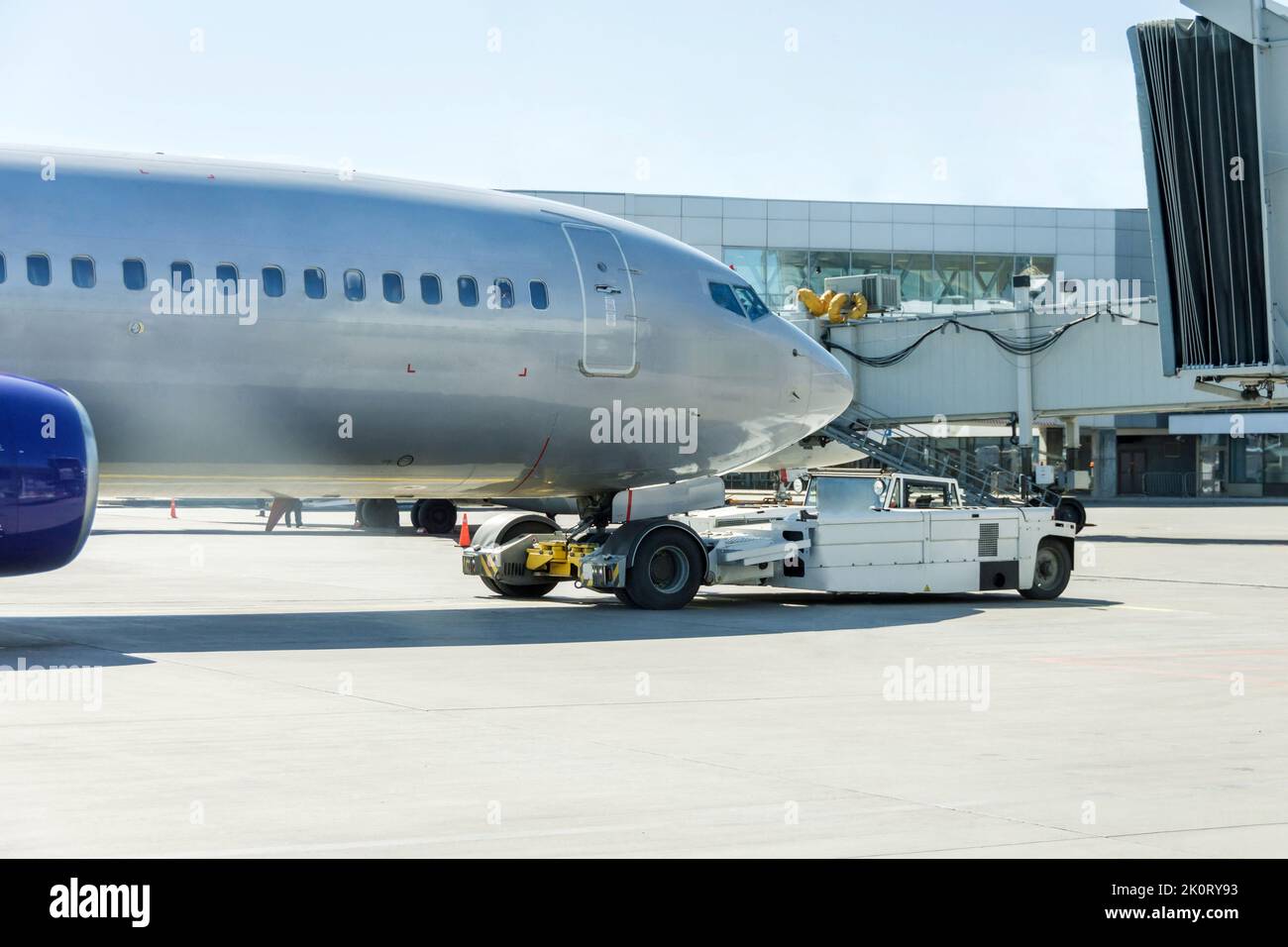 Commercial passenger airplane during push back operation. Shiny metal ...