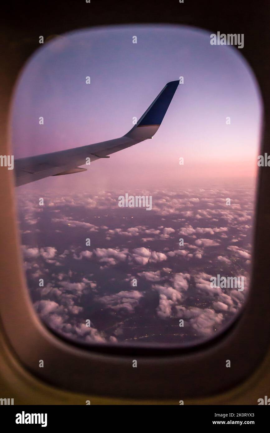 View outside of a plane window in flight at dusk Stock Photo - Alamy