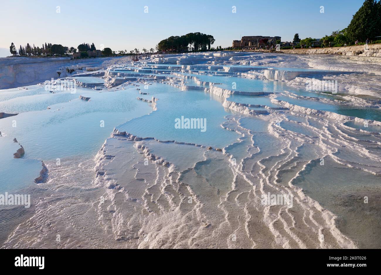 blue pools with water and white travertine terraces of Pamukkale ...
