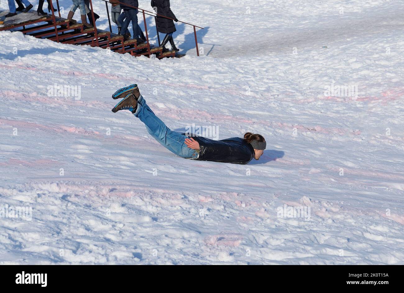 Adults riding down the ice slide on stomach just for fun Stock Photo ...