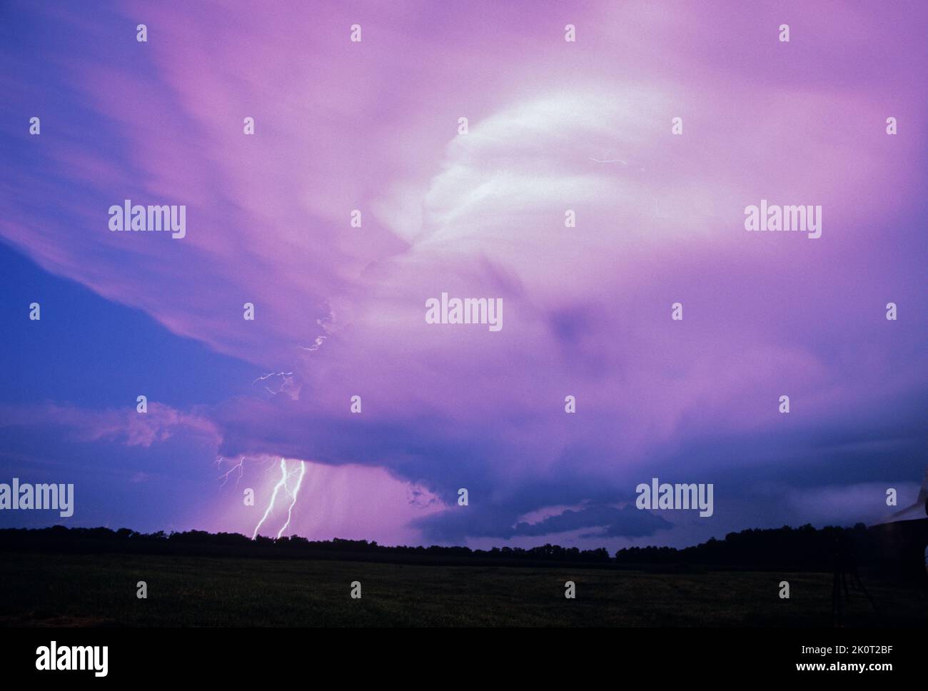 A massive supercell thunderstorm is lit by hundreds of internal ...