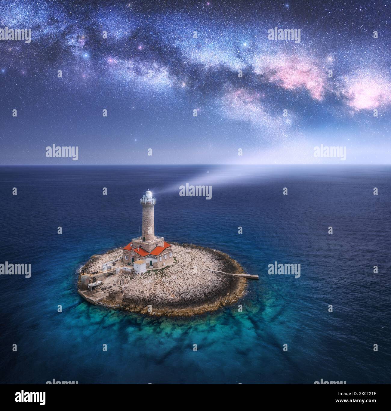 Lighthouse on smal island in the sea and Milky Way at night Stock Photo ...