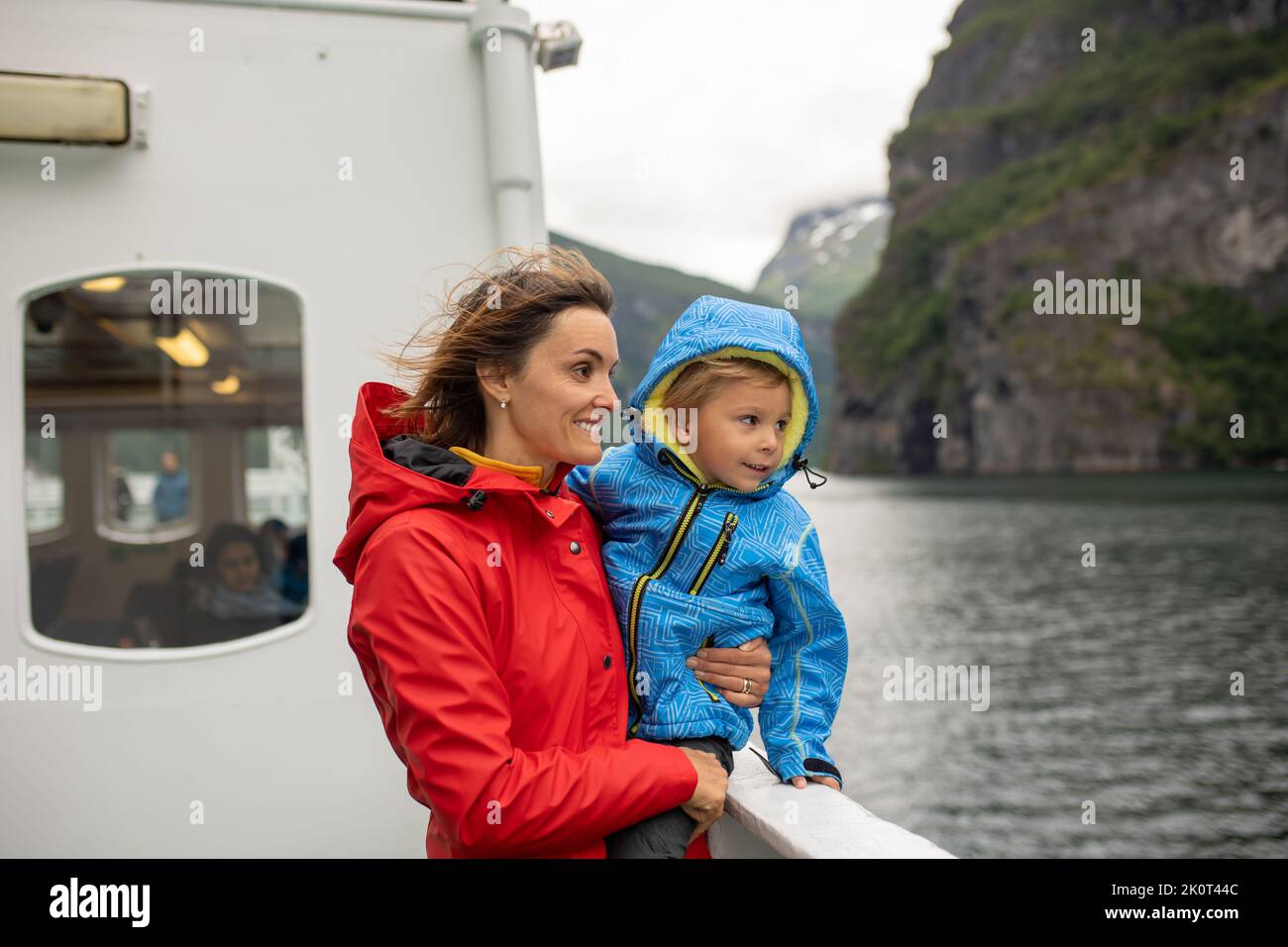 Family, kids and adults and a pet dog, enjoying trip to Geirangerfjord ...