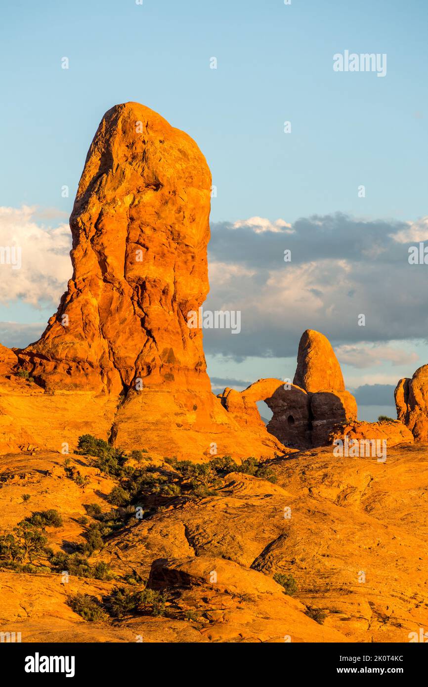 An Entrada sandstone rock spire with Turret Arch behind in Arches ...