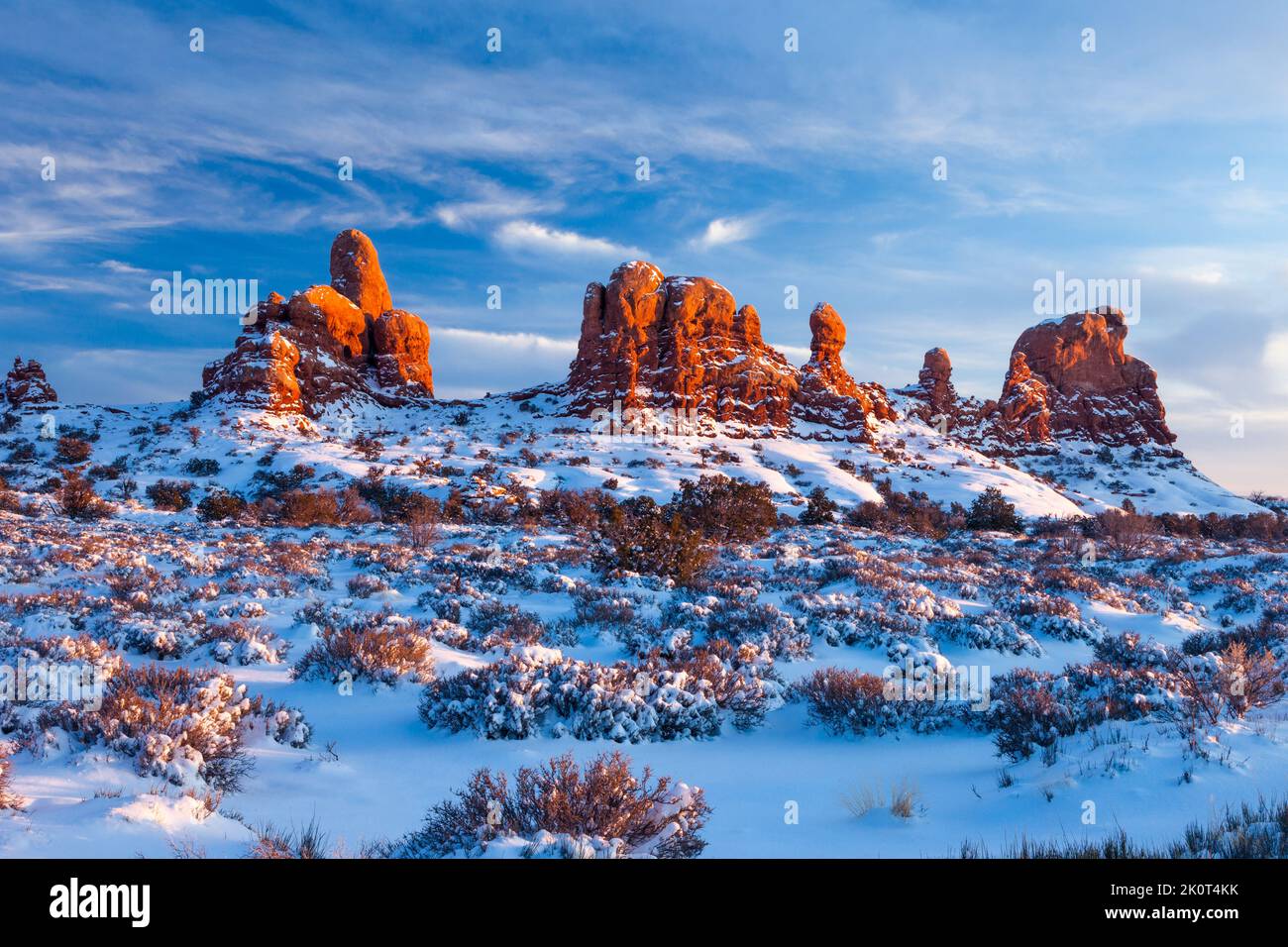 Entrada sandstone rock spires and side view of Turret Arch with snow in ...
