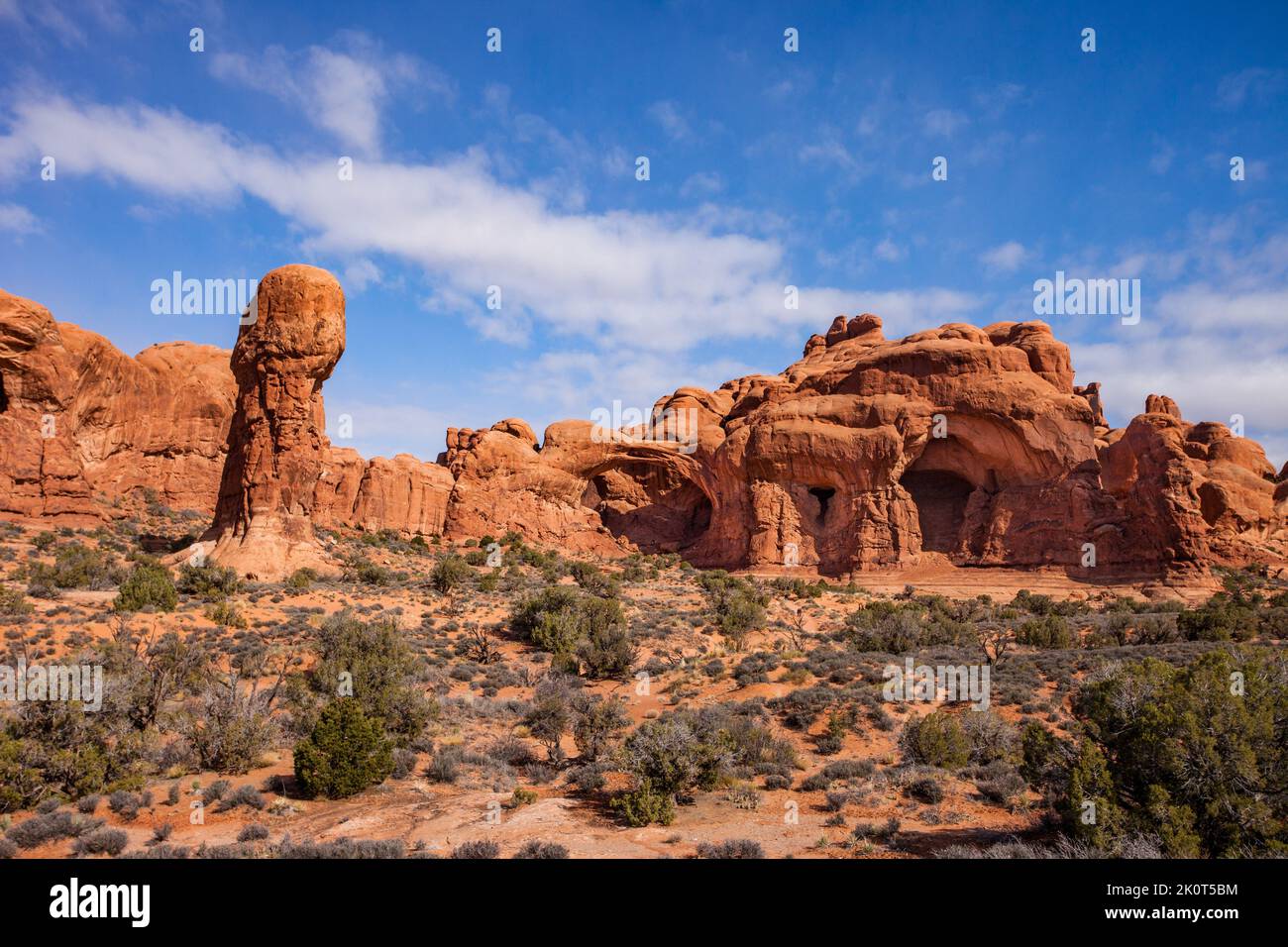 A sandstone rock spire with Double Arch, center, in the Windows Section ...