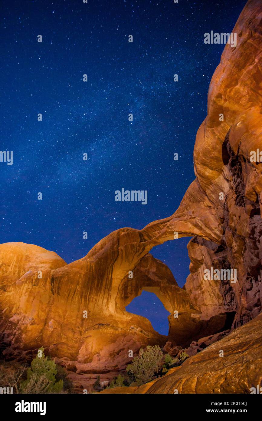 Double Arch at night with the MIlky Way, lit by the moon and light ...