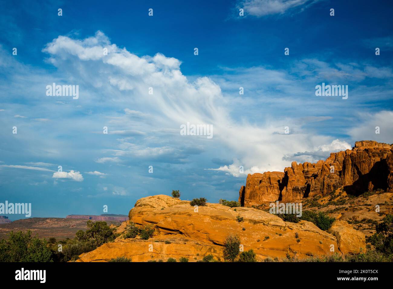 A developing thunderhead over Ham Rock Butte in Arches National Park ...