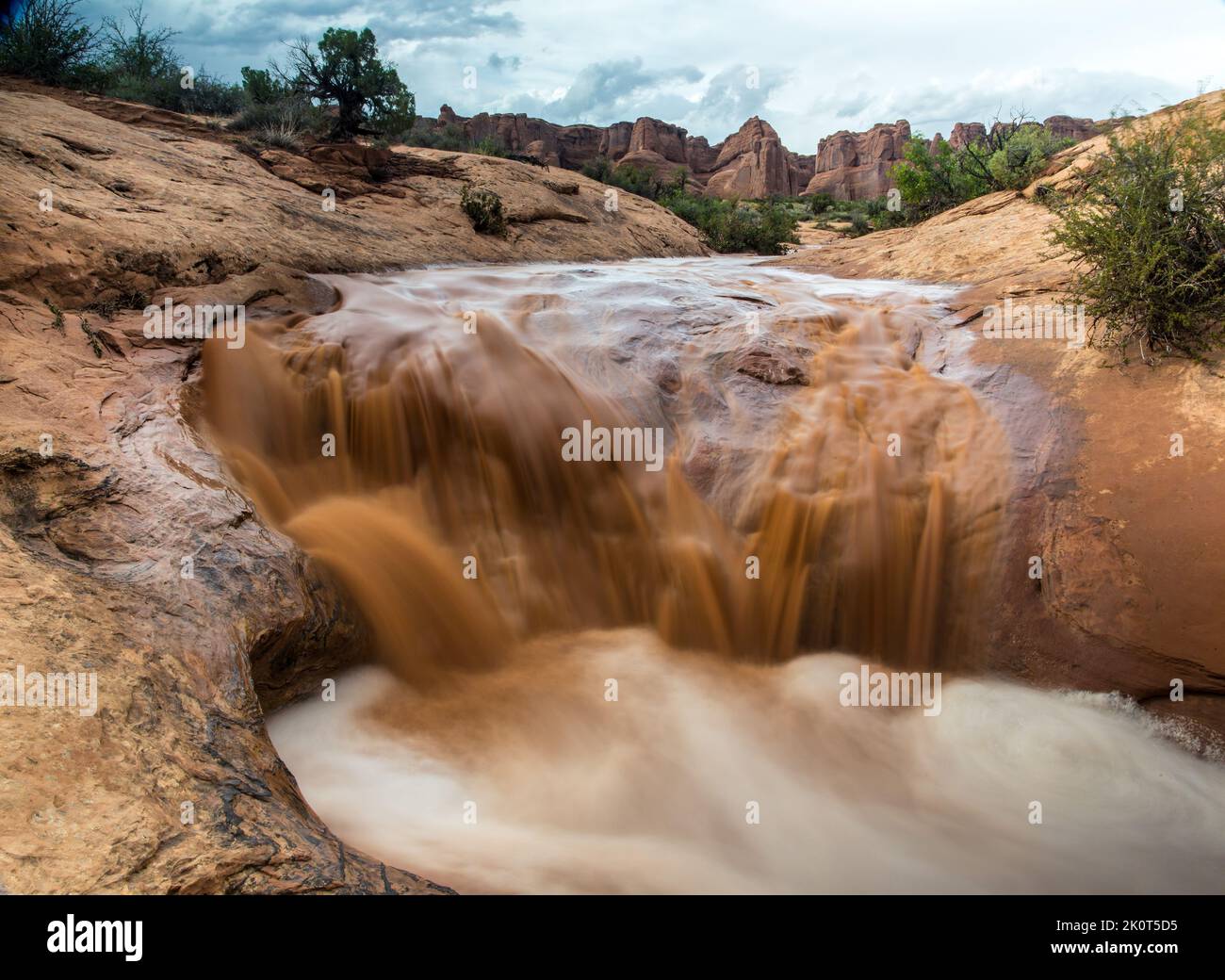 A flash flood in the desert after a heavy rain in Arches National Park ...