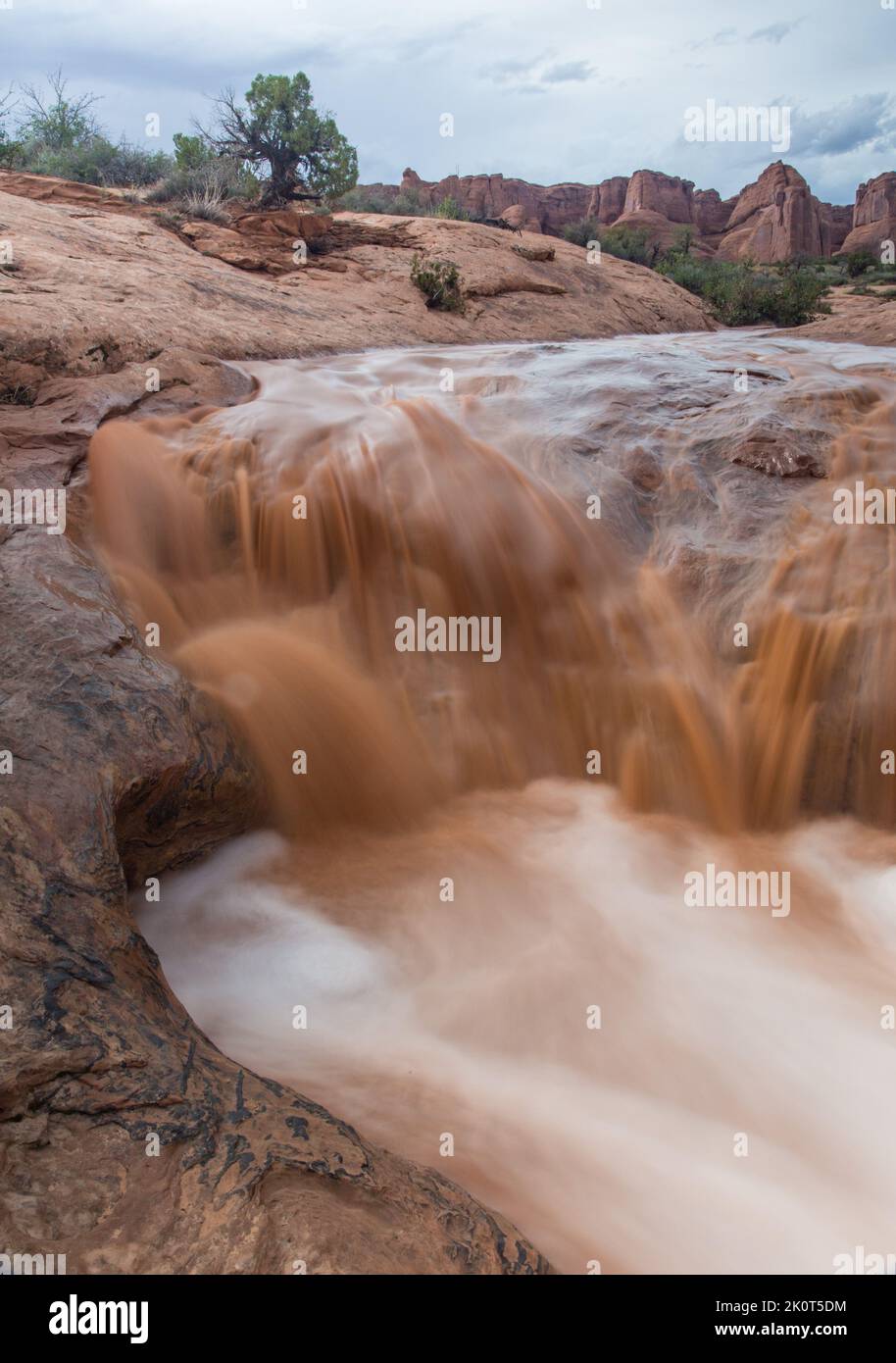 A flash flood in the desert after a heavy rain in Arches National Park ...