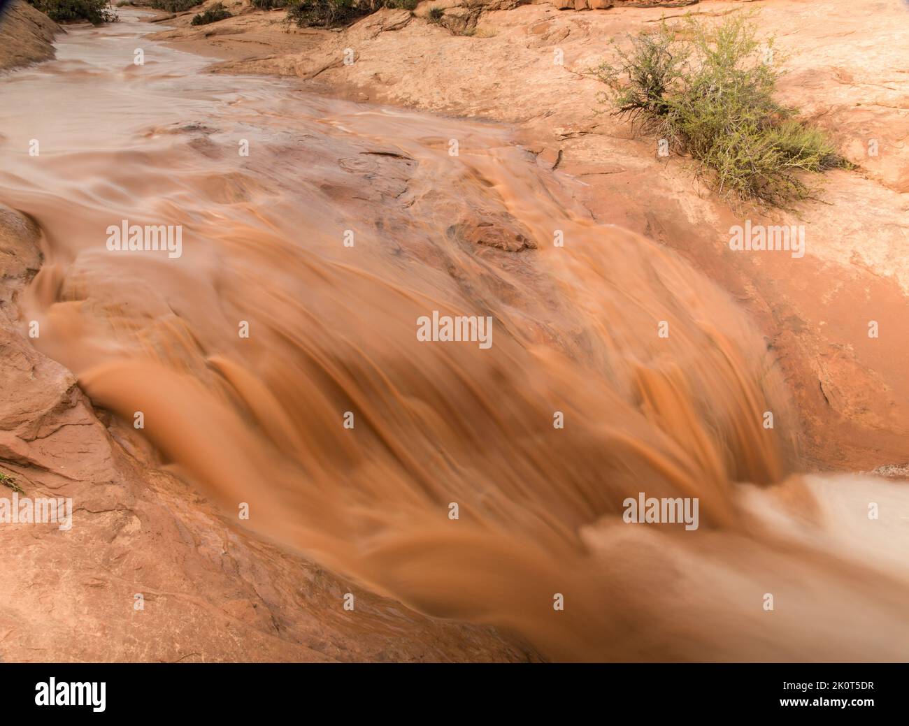 A flash flood in the desert after a heavy rain in Arches National Park ...