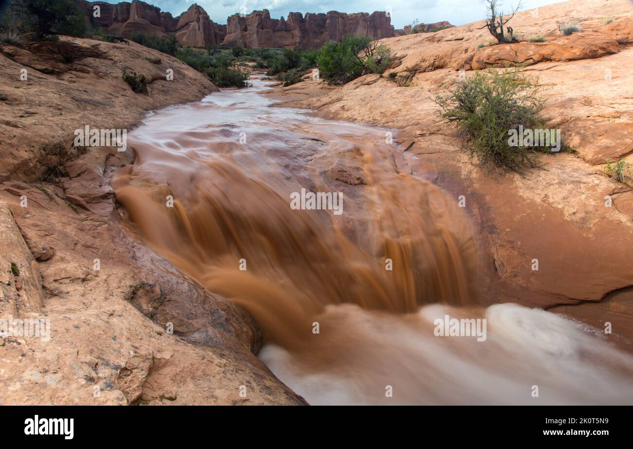 A flash flood in the desert after a heavy rain in Arches National Park ...