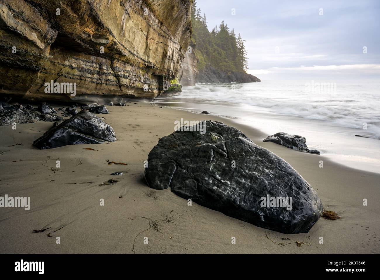 A scenic shot of a beautiful isolated beach with rocks and cliffs in ...