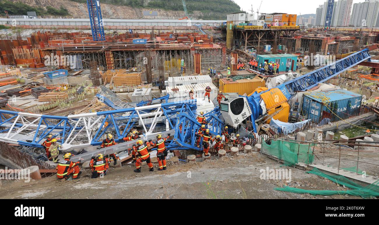 Firefighters work to rescue the injured; a tower crane collapsed on a ...