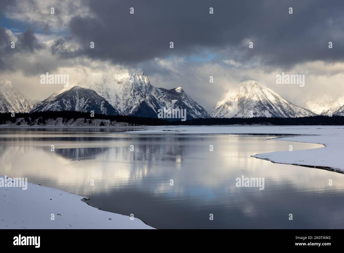 Mount Moran and Traverse Peak rising above Jackson Lake with low water ...