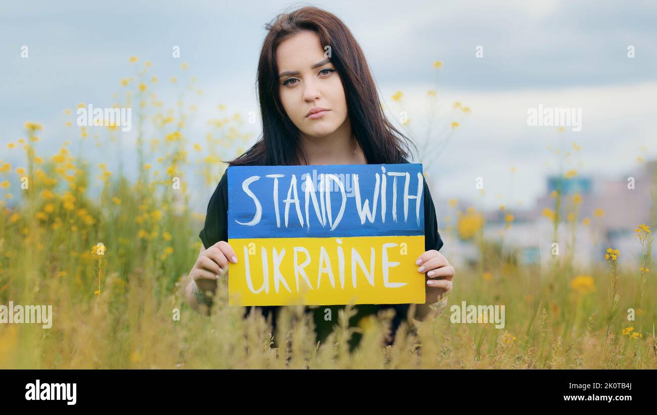 Sad female ukrainian girl migrant woman upset lady posing in field ...
