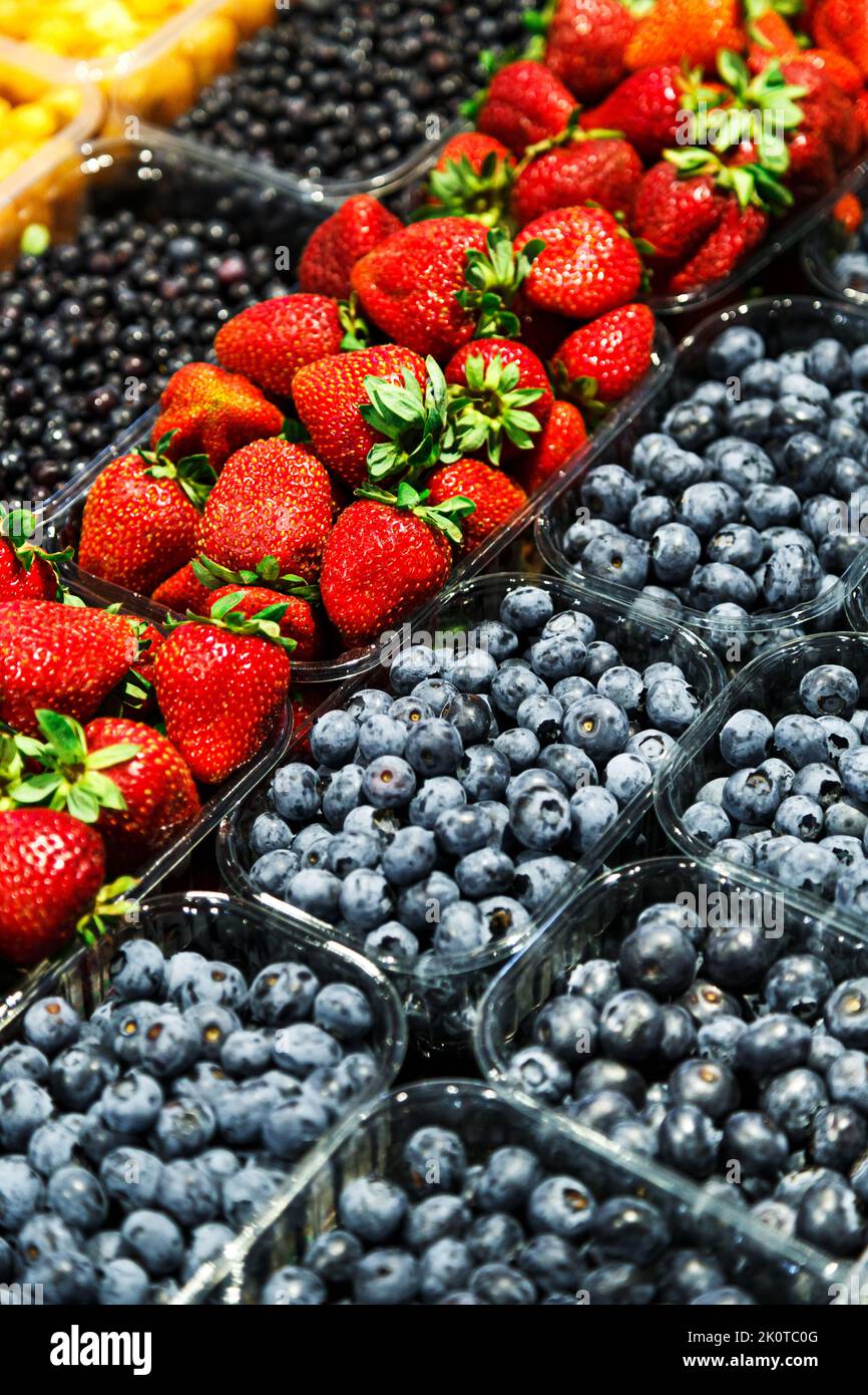 Colourful mix of different fresh berries at market. Strawberries ...