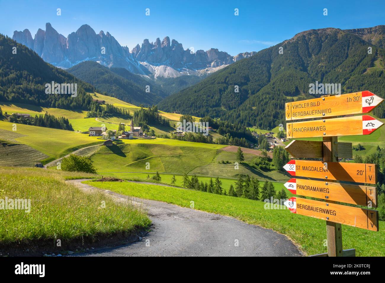 St. Magdalena village road sign with church in Val di Funes, Dolomites ...