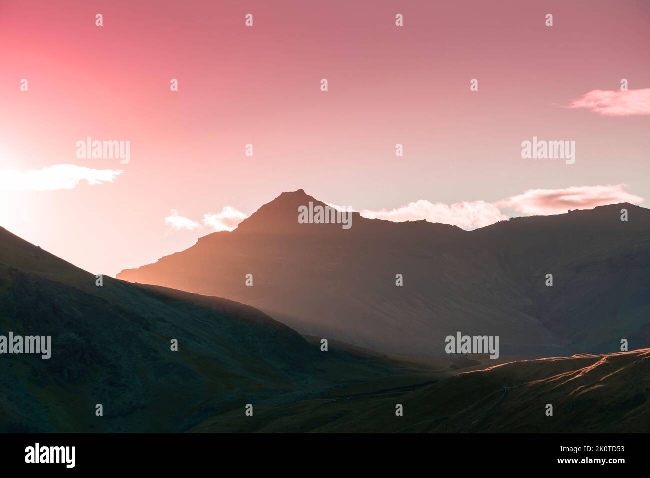 Sunset through mountains with sunrays, Iceland - HDR photograph Stock ...