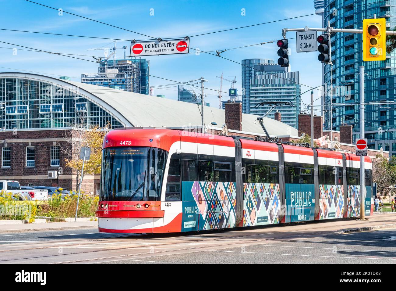 A modern TTC Bombardier streetcar or tramway drives in the city. The ...