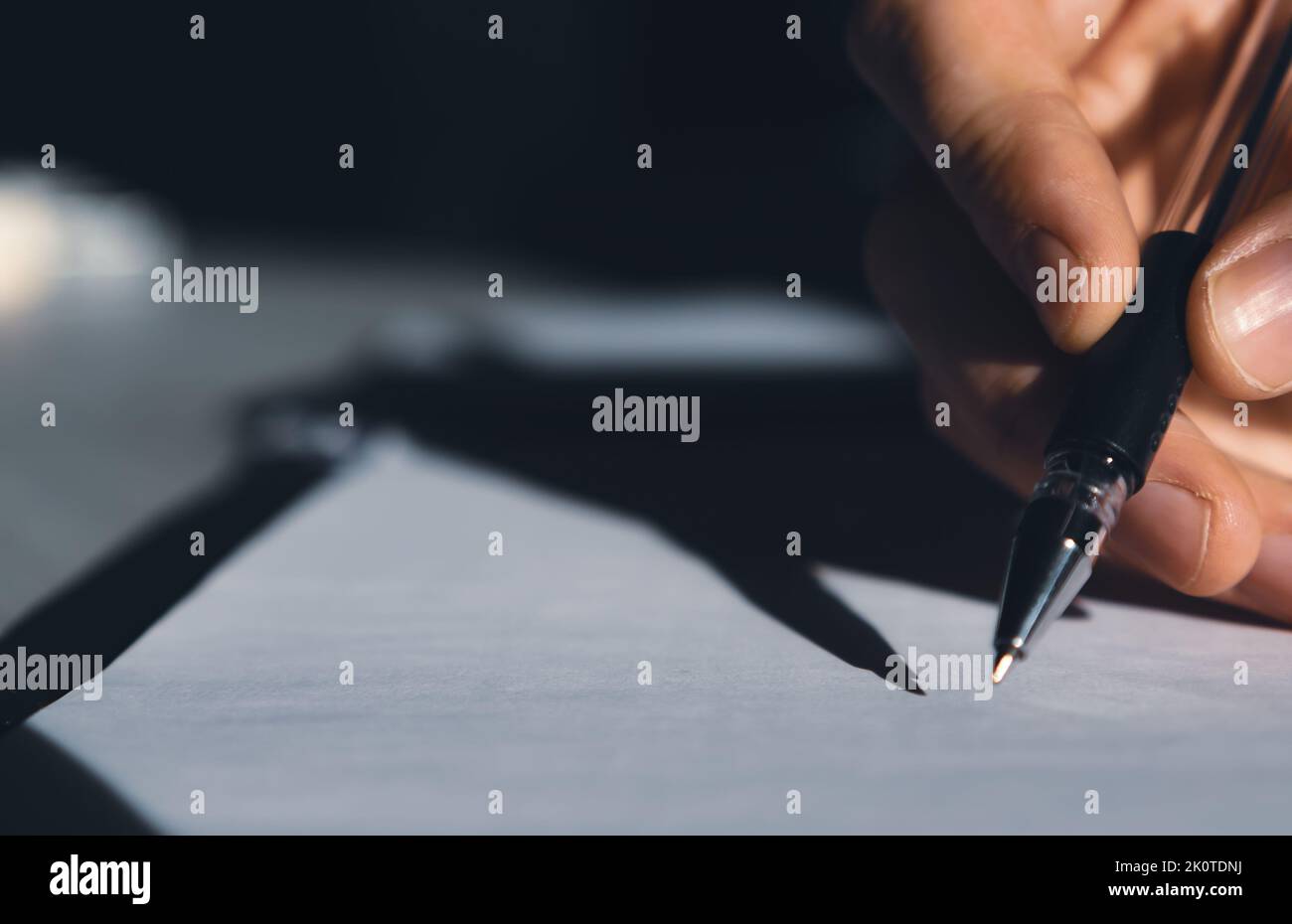 Close up view of a person about to sign an important document in his ...
