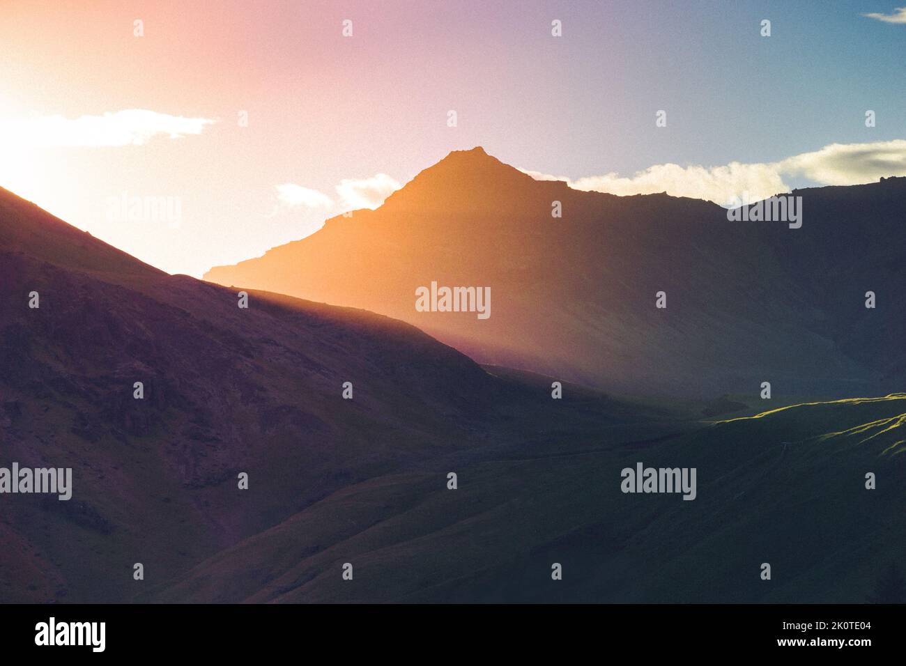 Sunset through mountains with sunrays, Iceland - HDR photograph Stock ...