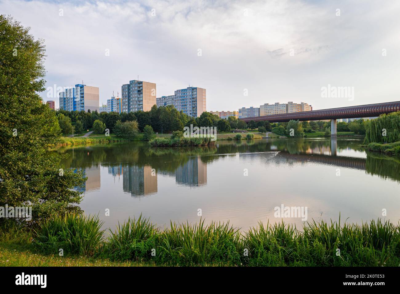 Small lake in a city park and high-rise apartment buildings in suburban ...