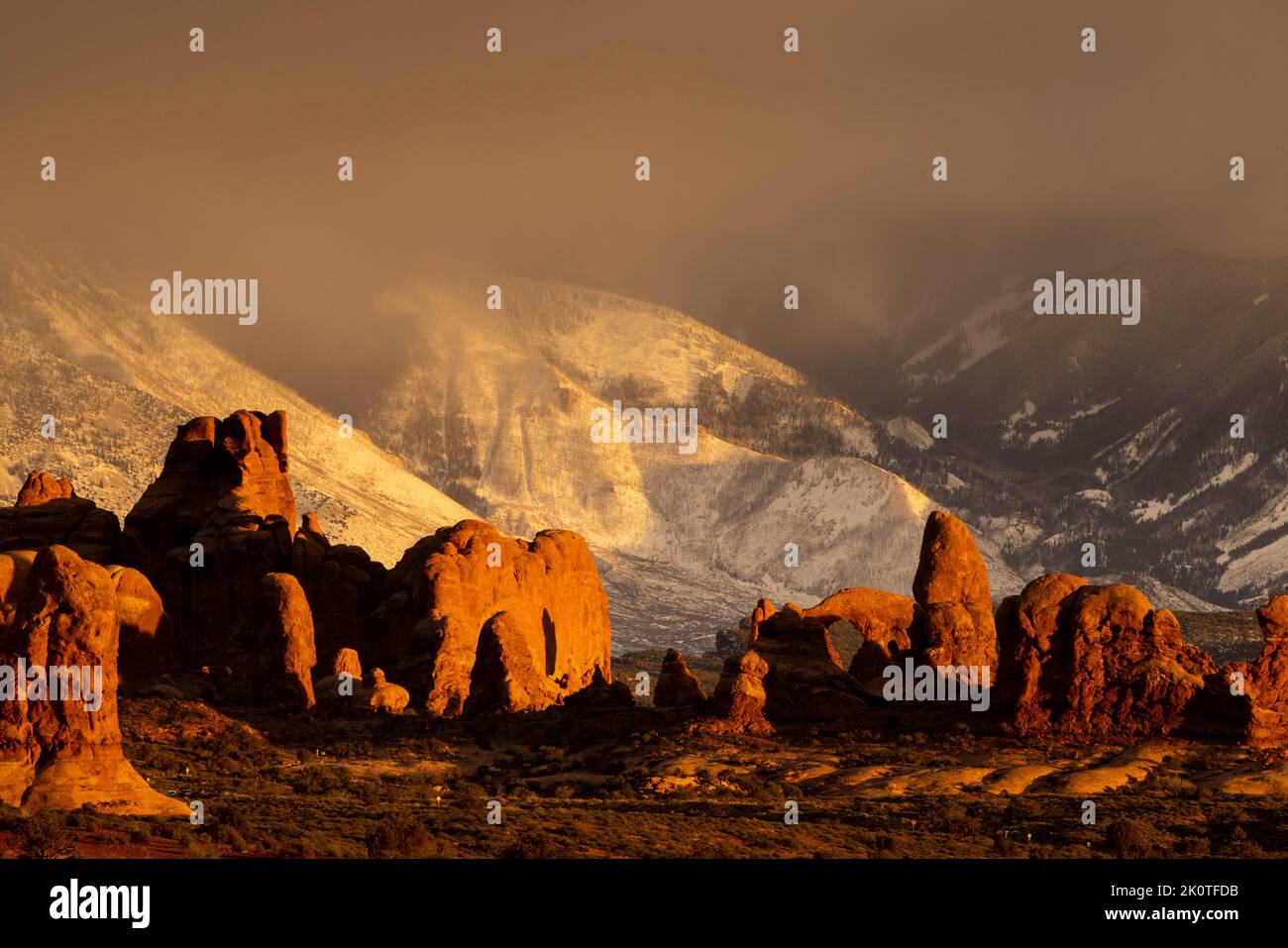 The La Sal Mountains, engulfed in a winter storm, reflecting golden ...