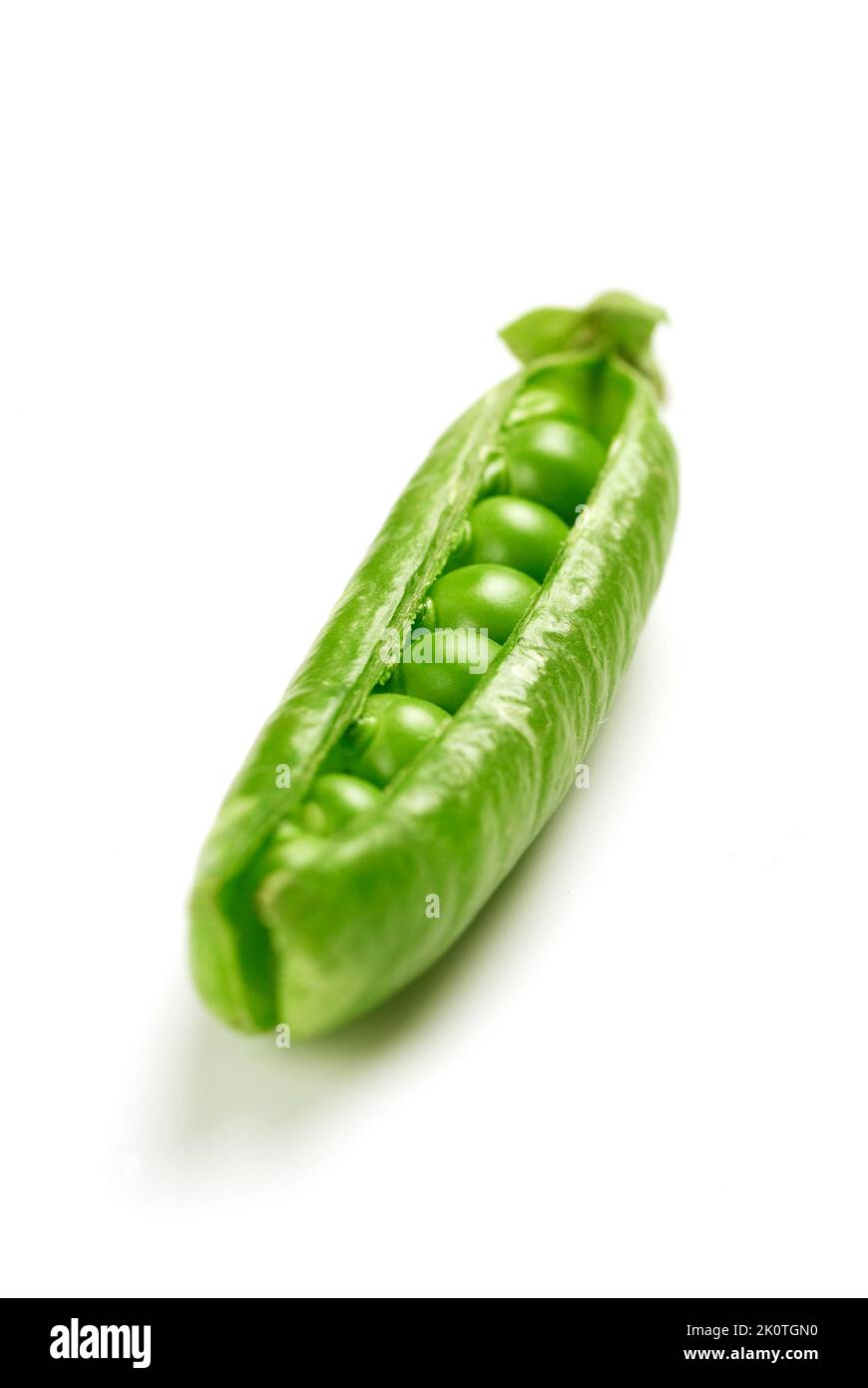 Single pea pod opened on white background cut out Stock Photo - Alamy