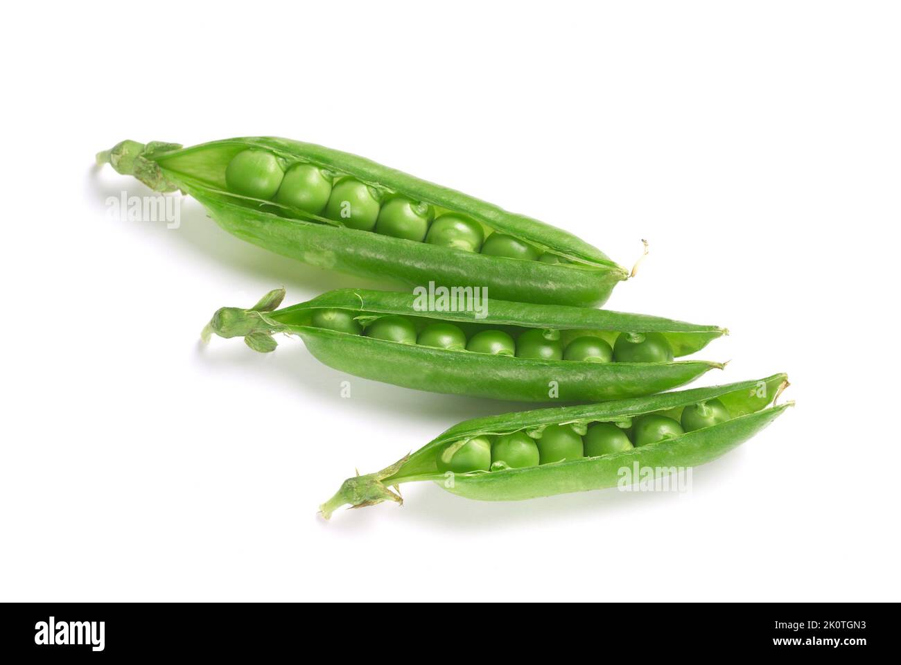 Three pea pods open revealing the peas inside cut out Stock Photo - Alamy