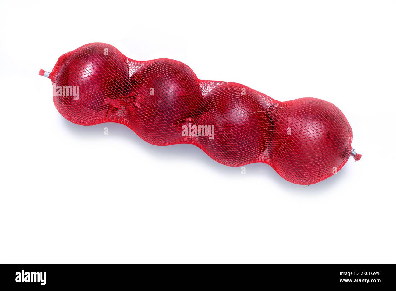 Four red onions in net packaging, isolated on white background, shot ...