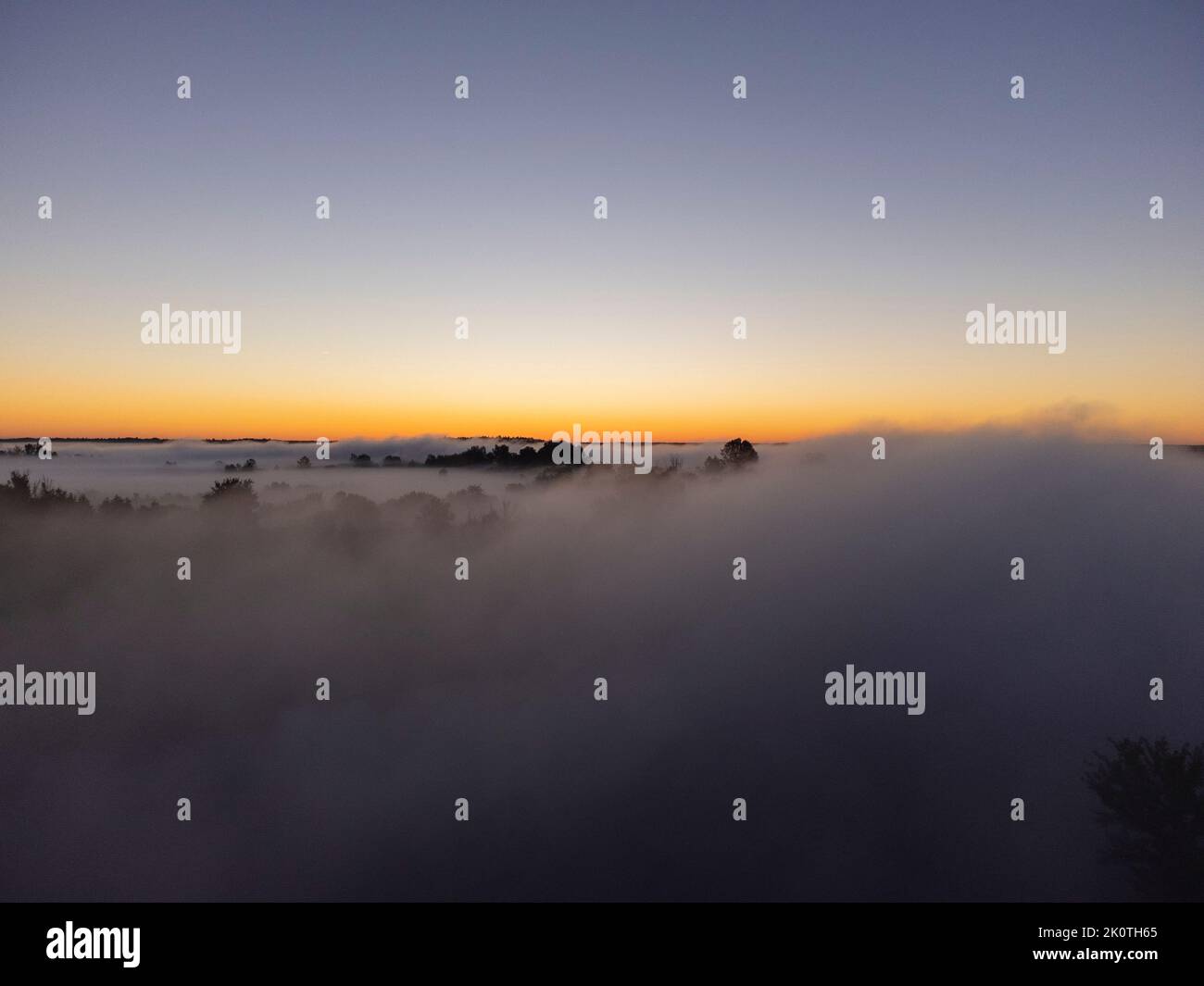 Pictures of the drone flight over the fog. River, forest, fields and ...