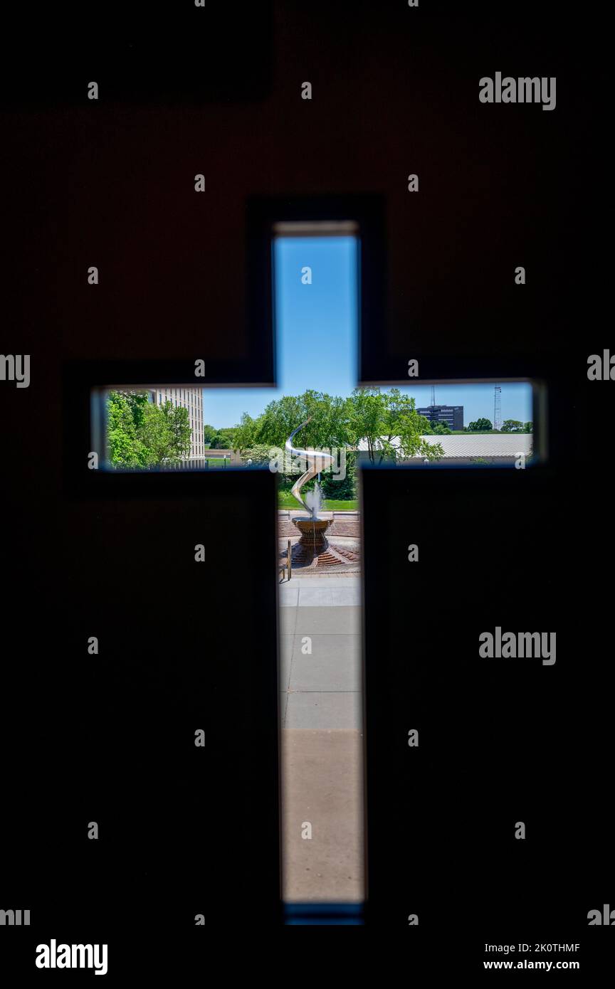 Omaha, Nebraska, US - 5.2022 - View out of a cross window of St. John's ...