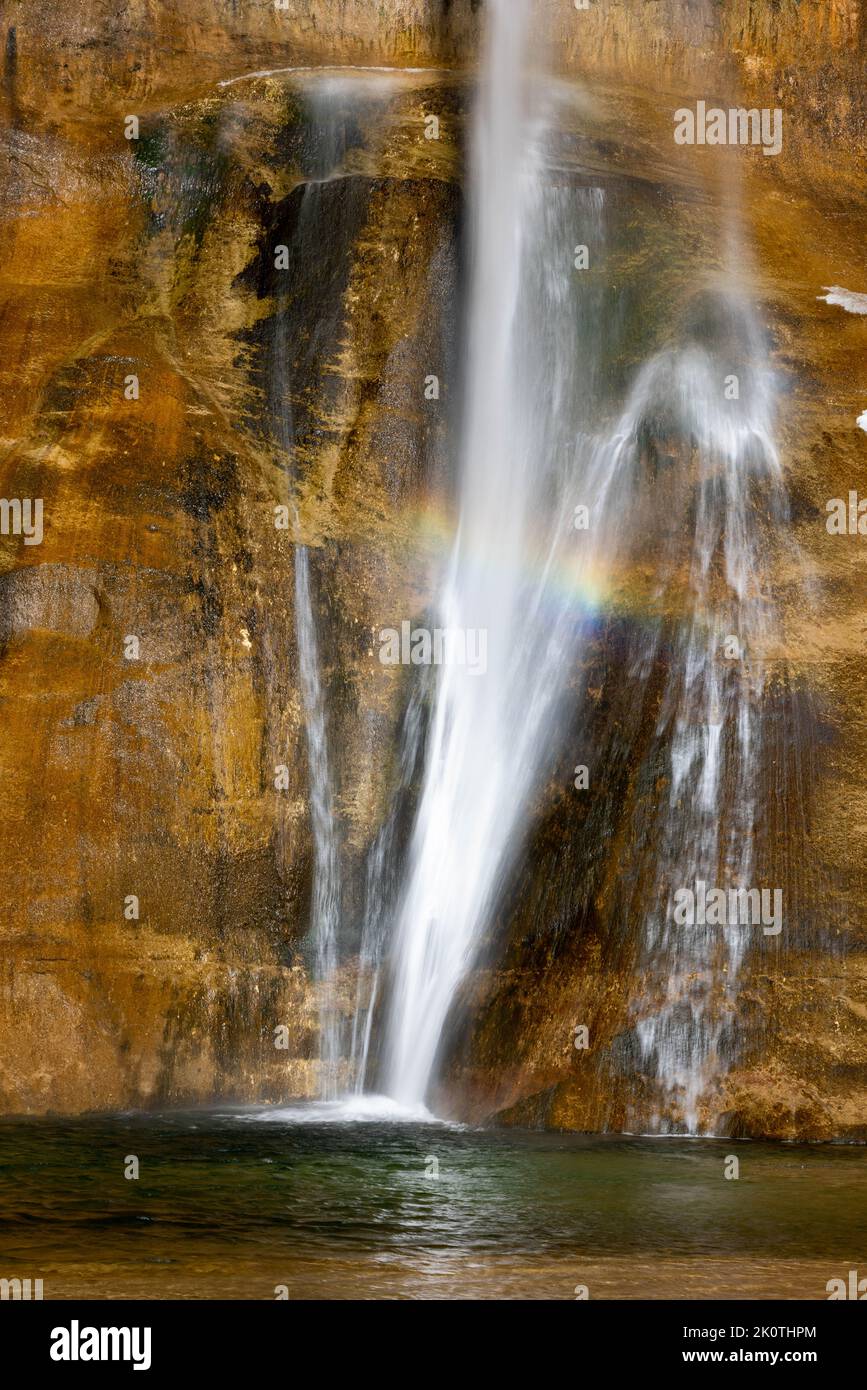 A small rainbow arching through the bottom of Lower Calf Creek Falls ...