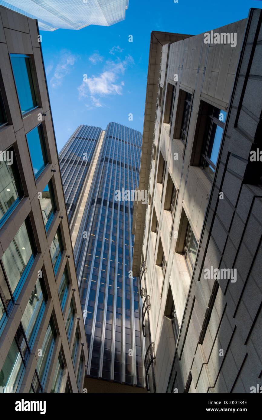 view up between older lower buildings with modern glass facade ...