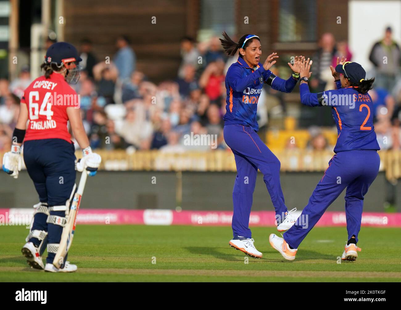 India's Harmanpreet Kaur and Sneh Rana celebrate the wicket of England ...